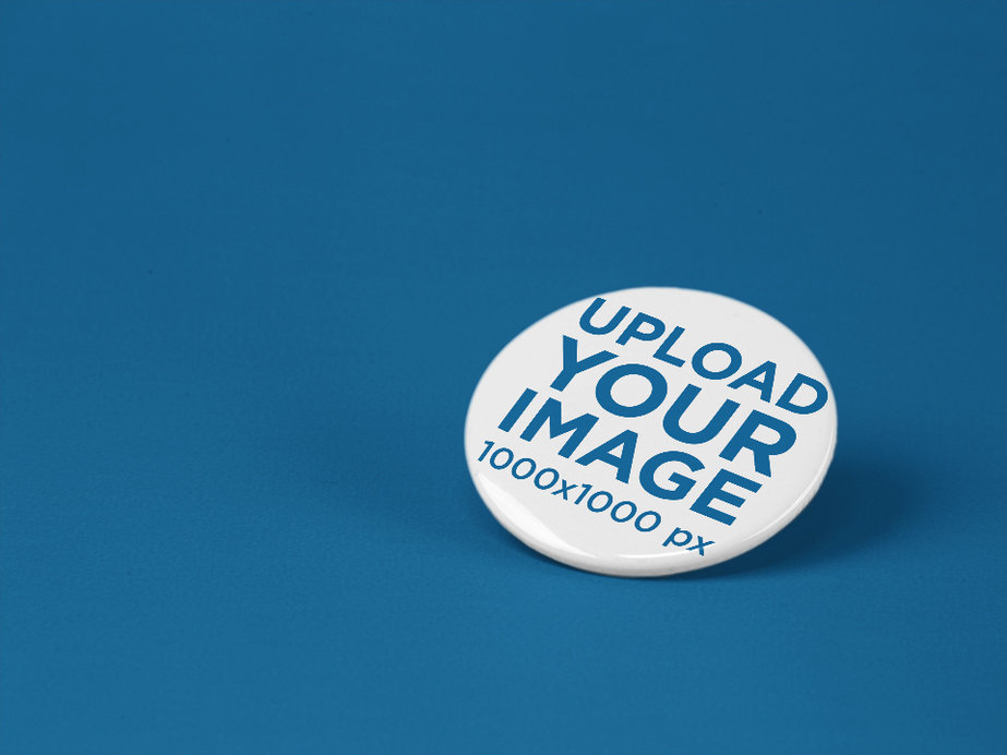 Placeit - Button Mockup Lying on a Solid Color Surface
