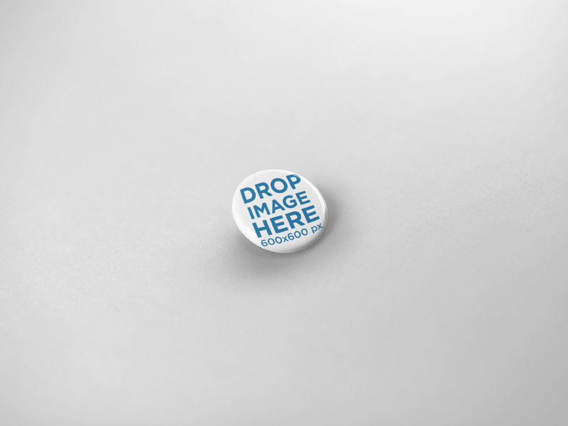 Placeit - Little Button Template Lying on a Solid Color Surface