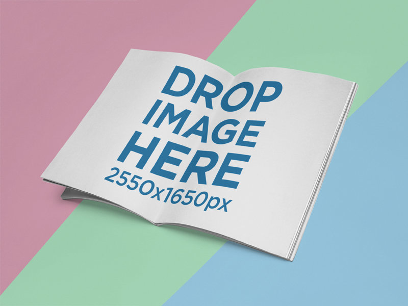 Placeit - Mockup of an Open Magazine Lying on a Multicolor Surface