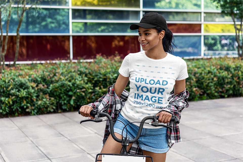 Placeit - T-Shirt Mockup of a Happy Young Woman Riding Bicycle