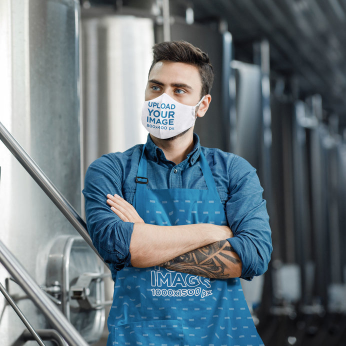 Placeit - Face Mask Mockup of a Tattooed Man Wearing an Apron at Work