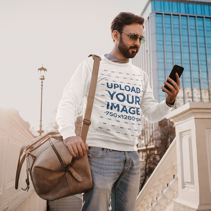 Placeit - Crewneck Sweatshirt Mockup of a Man With a Bag Checking His Phone