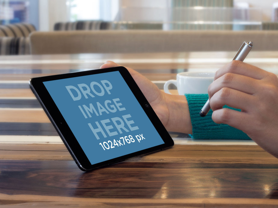 Placeit - Mockup of a Person Using an iPad Mini with a Touchscreen Pen